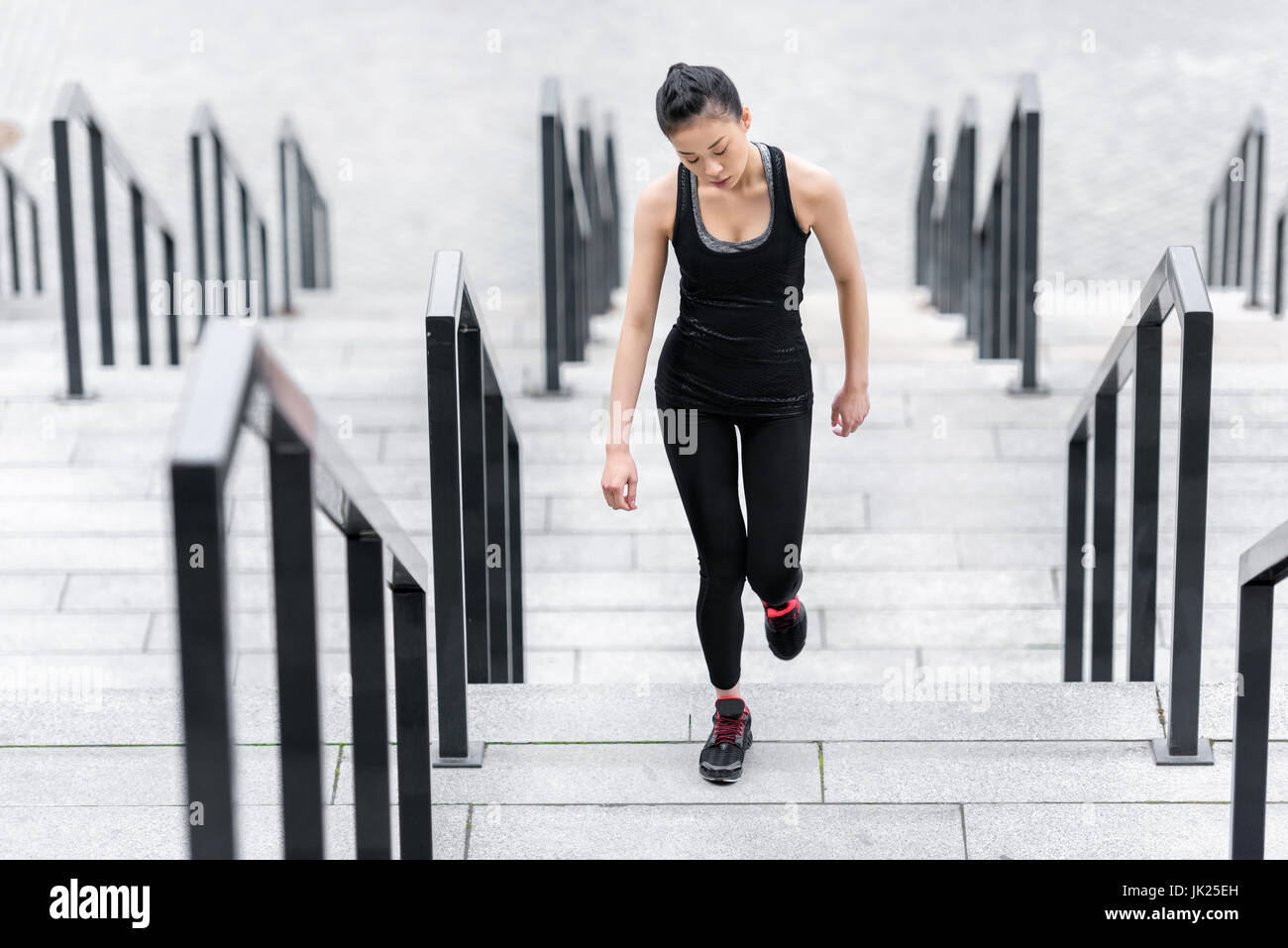 Young woman running down stairs hi-res stock photography and images - Alamy