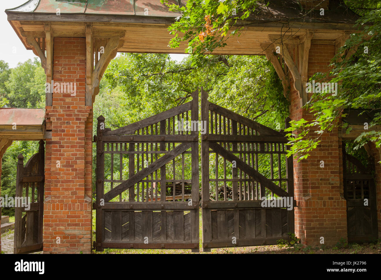 Wooden vintage antique gate and brick columns Stock Photo - Alamy