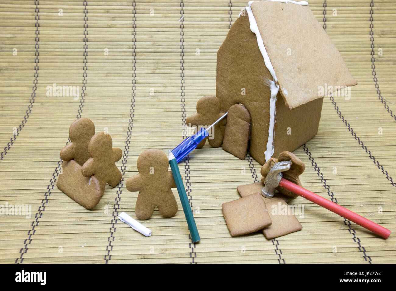 Gingerbread man cookies building house with small tools Stock Photo - Alamy