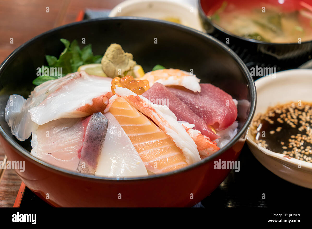Japanese food with raw fishes, called sashimi on the rice in Bowl in ...