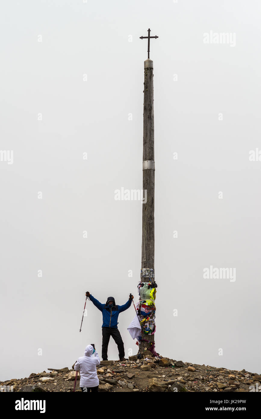 Pilgrims on the Cruz de Ferro, Spain. Camino de Santiago Stock Photo - Alamy