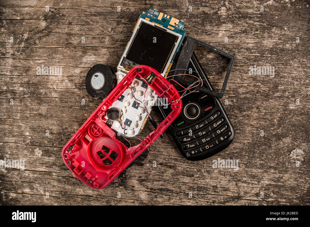 Close up of first generation mobile cellphone on wooden background ...