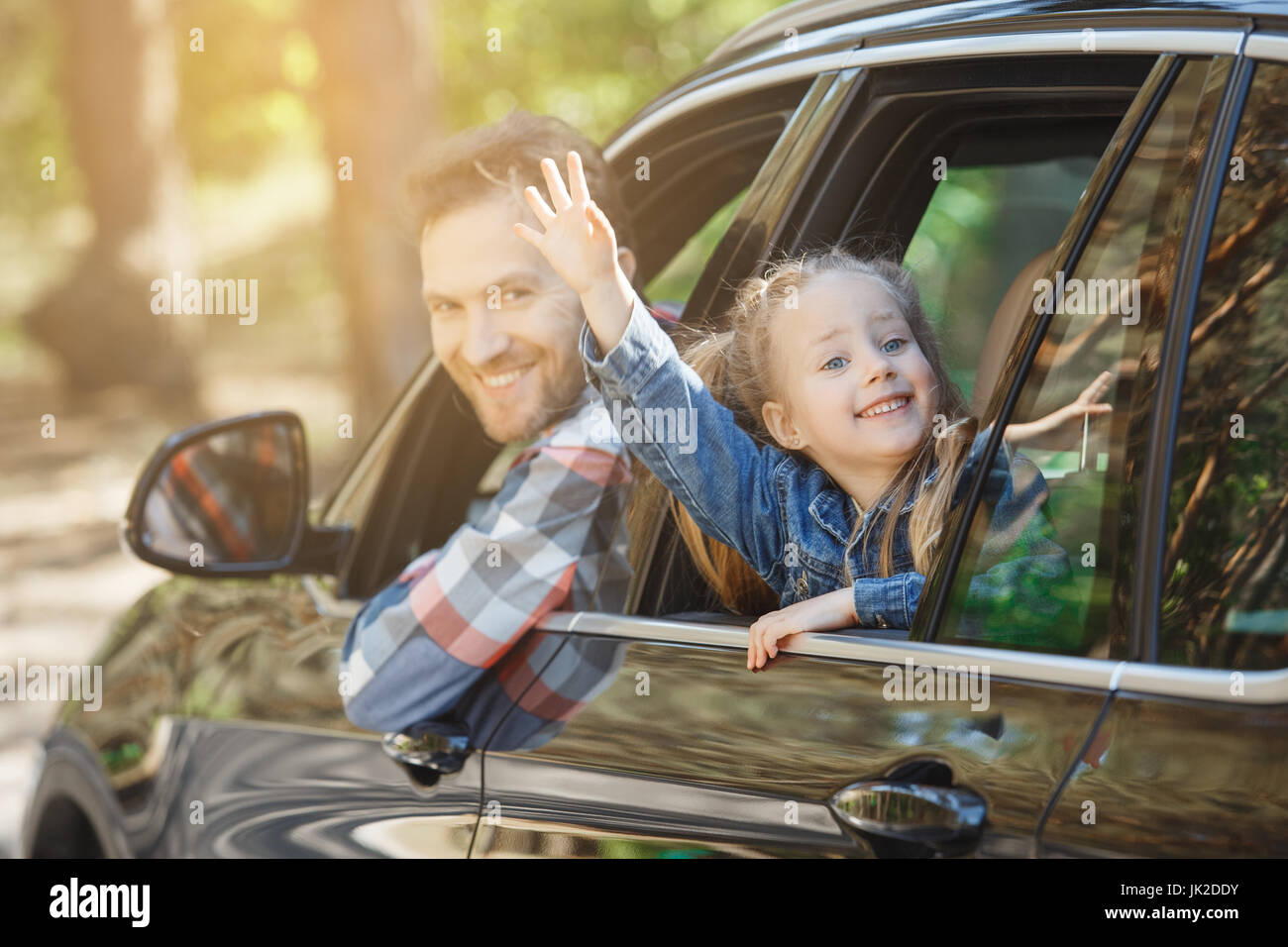 Travel by car family ride together father and daughter lean out of the ...