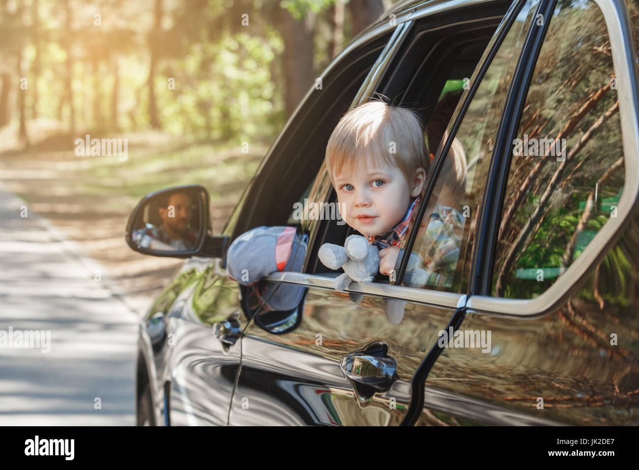Travel by car family ride together boy lean out of the window Stock ...