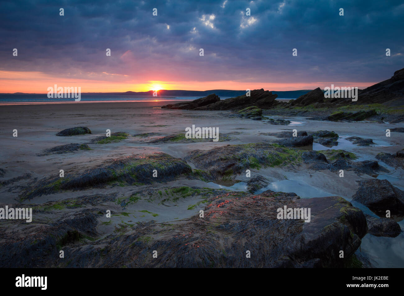 View over rock pools at sunset on Newgale beach, Pembrokeshire, Wales ...