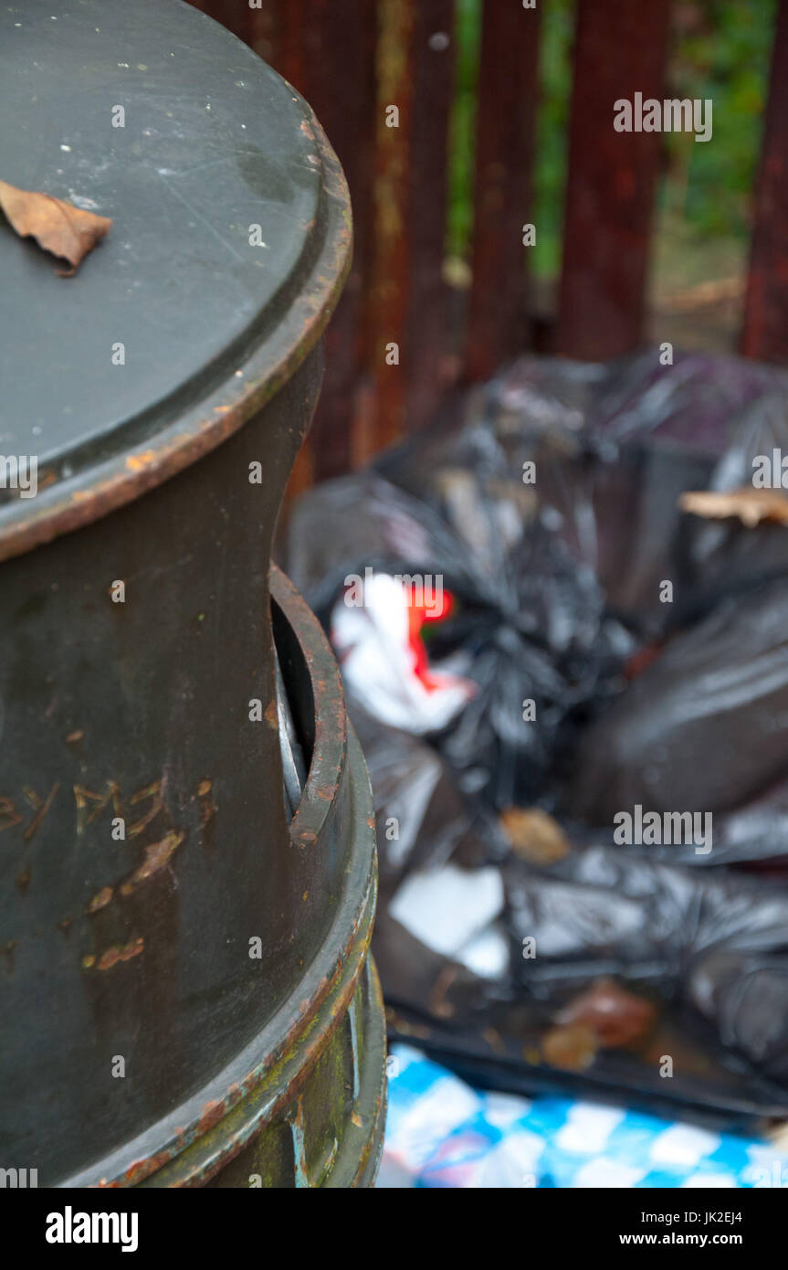 Litter piled up beside a street litter bin Stock Photo - Alamy