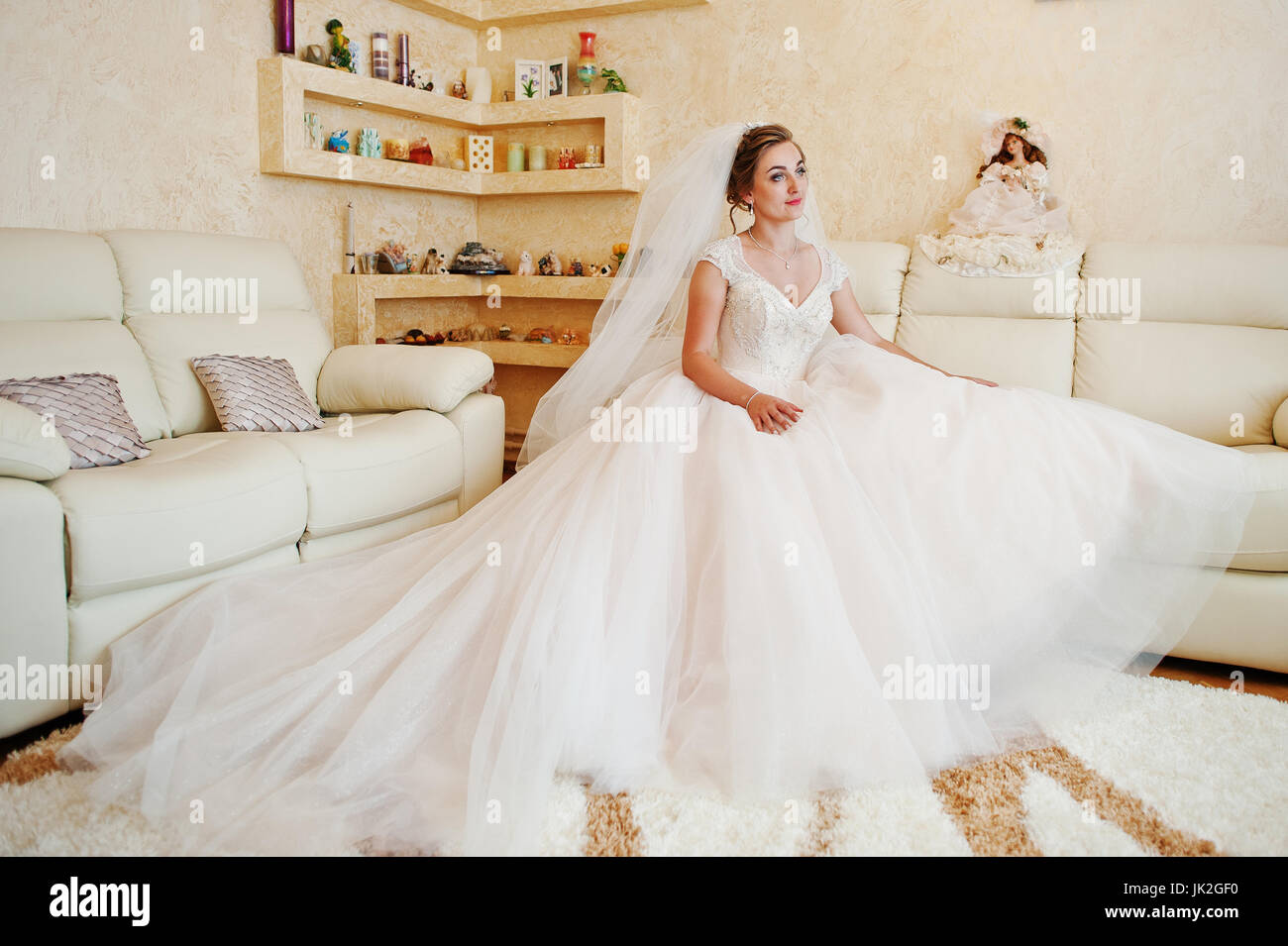 Portrait of a fabulous bride posing in her house on the wedding day ...