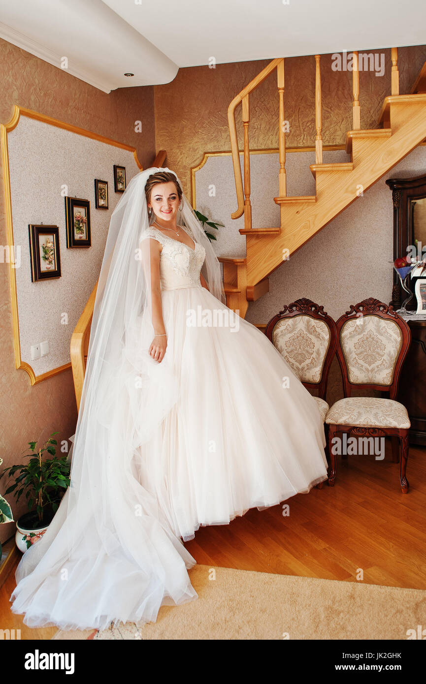 Portrait of a fabulous bride posing in her house on the wedding day ...