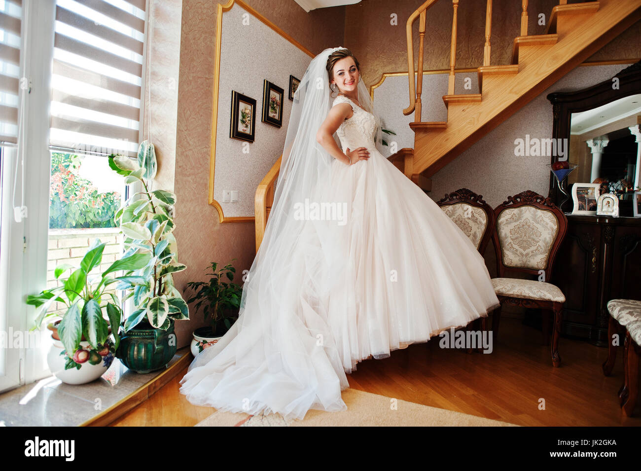 Portrait of a fabulous bride posing in her house on the wedding day ...