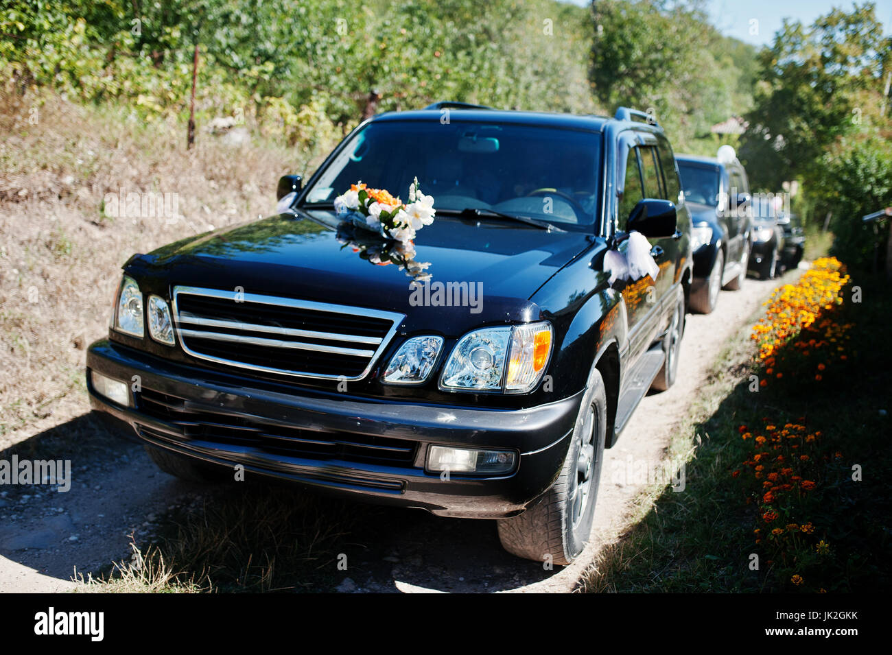 Gorgeous decorated black wedding suv Stock Photo - Alamy