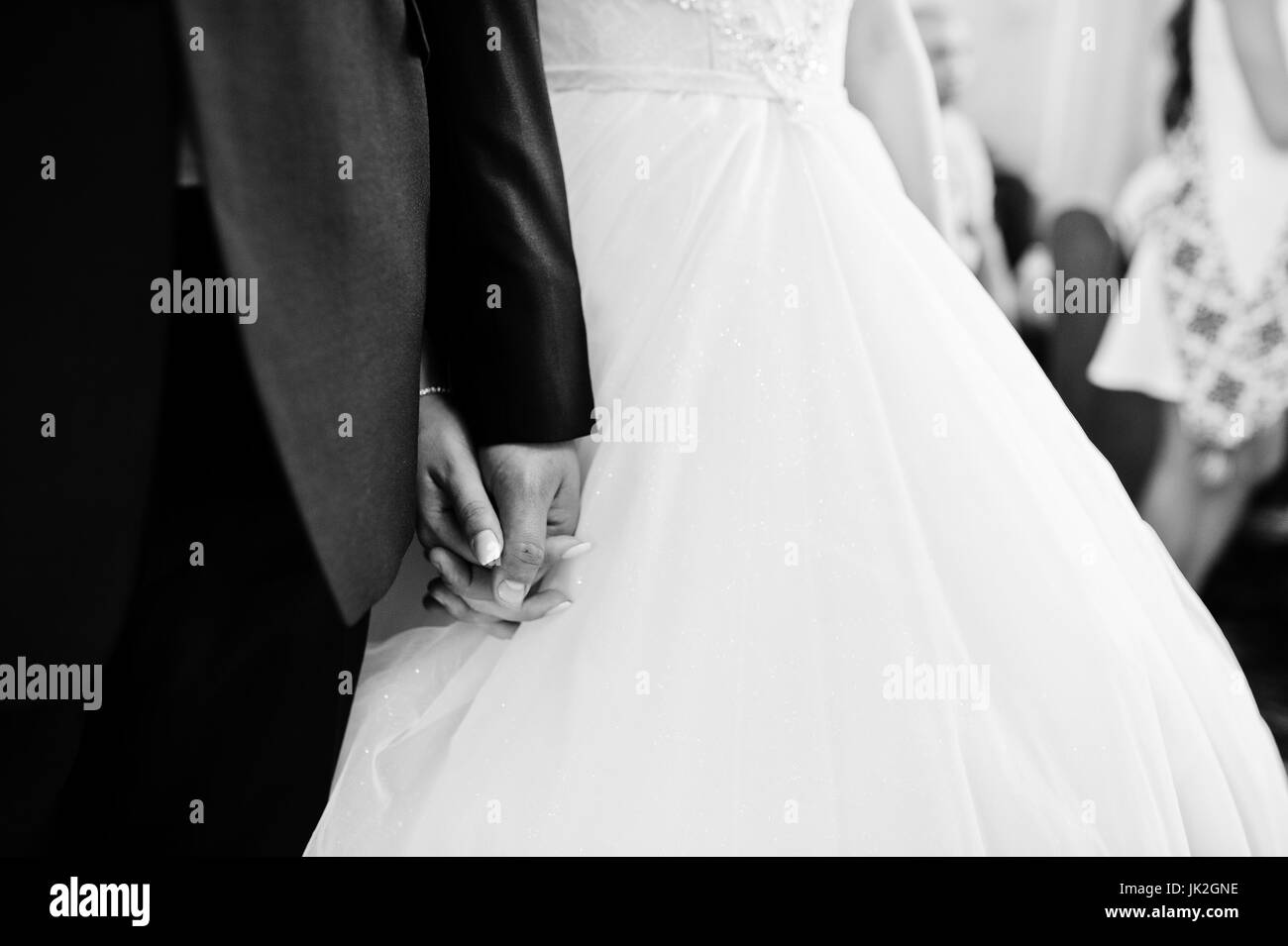 Beautiful couple standing in the church during wedding ceremony. Black ...