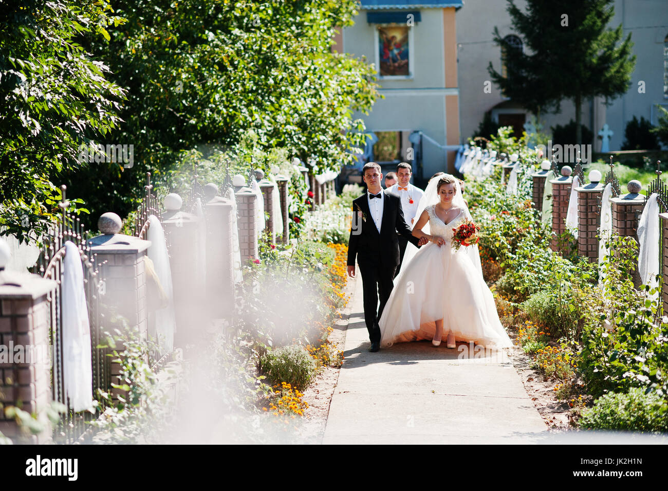 Bride and groom walking out of church hi-res stock photography and ...