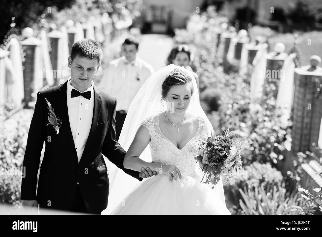 Bride and groom walking out of church hi-res stock photography and ...