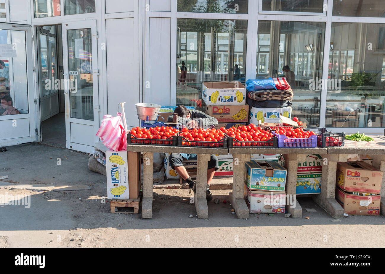 Peasant having a siesta, tomatoes booth/ stand on a farmer´s market day ...