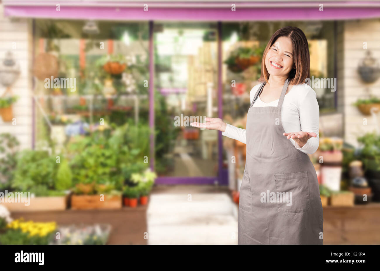 asian female florist with flower shop background Stock Photo - Alamy