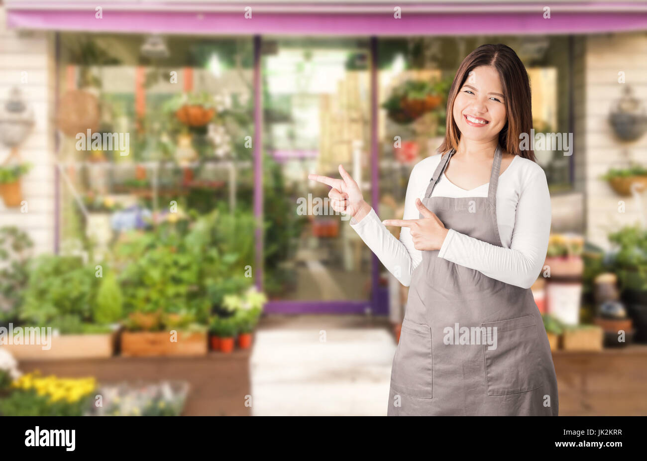 asian female florist with flower shop background Stock Photo - Alamy