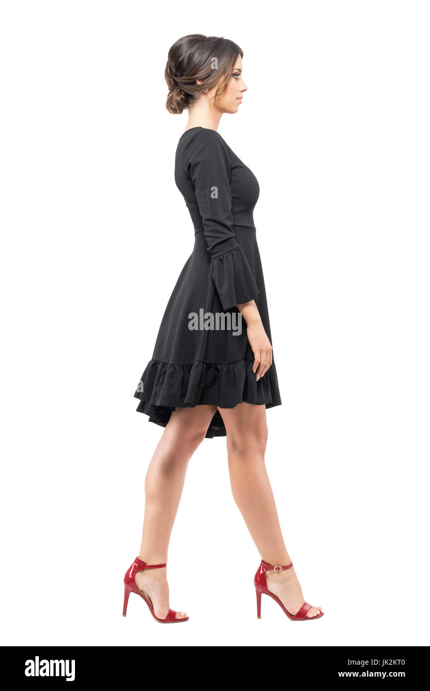 Hispanic woman in black dress and red high heels sandals walking ...