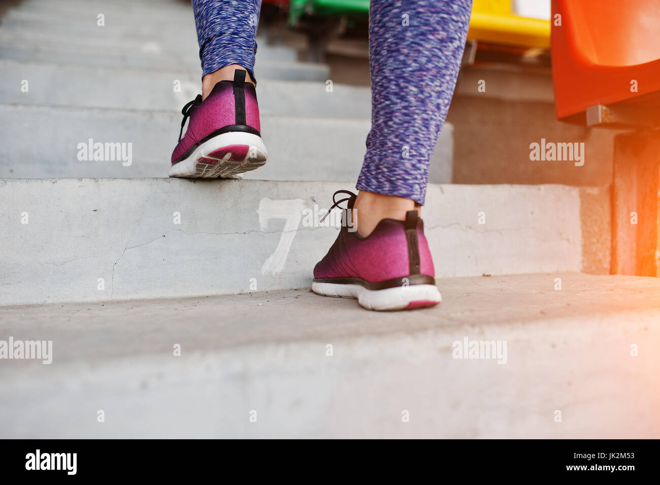 Active young woman running up on stairs in the stadium Stock Photo - Alamy