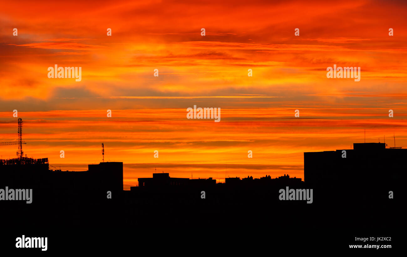 Vivid sunrise over the city buildings in morning Stock Photo - Alamy