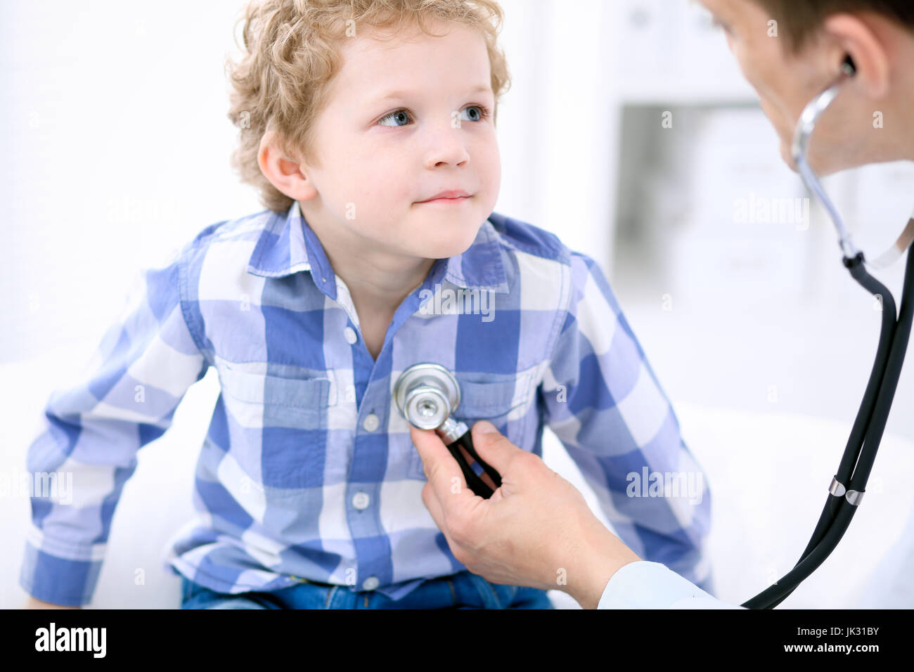 Doctor examining a child patient by stethoscope Stock Photo - Alamy