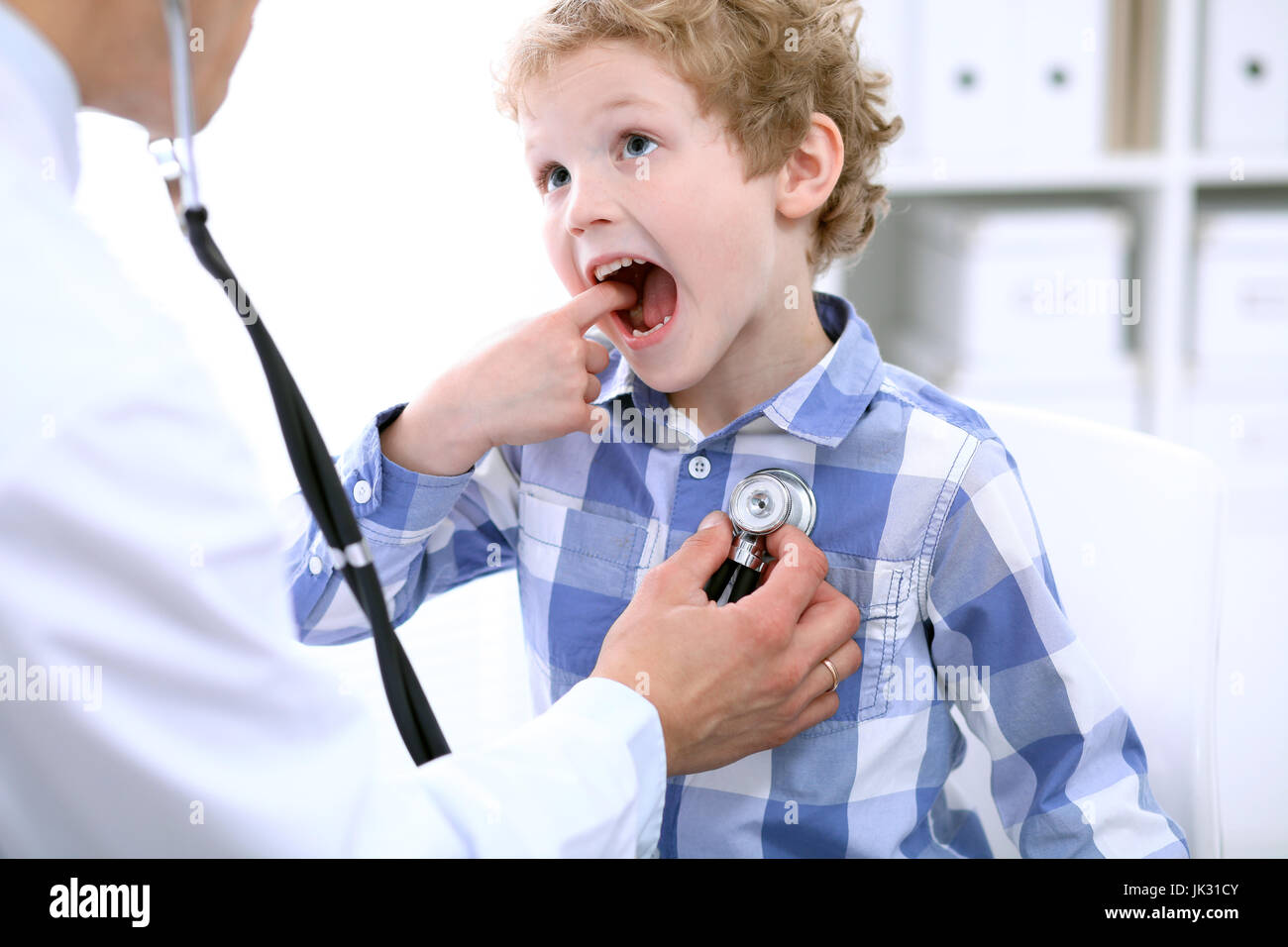 Doctor examining a child patient by stethoscope Stock Photo - Alamy
