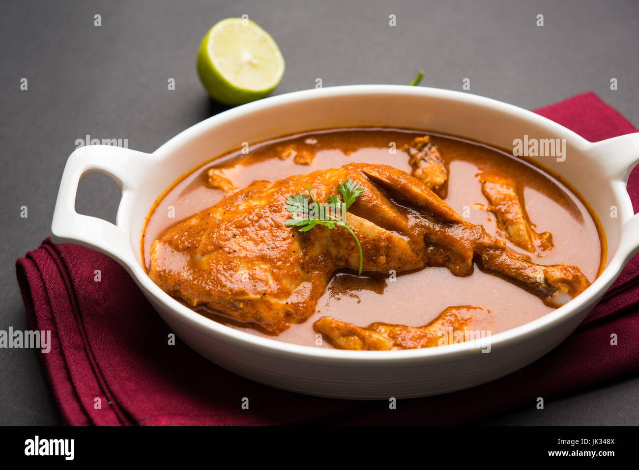 Indian spicy Chicken curry or masala chicken with prominent leg piece ...