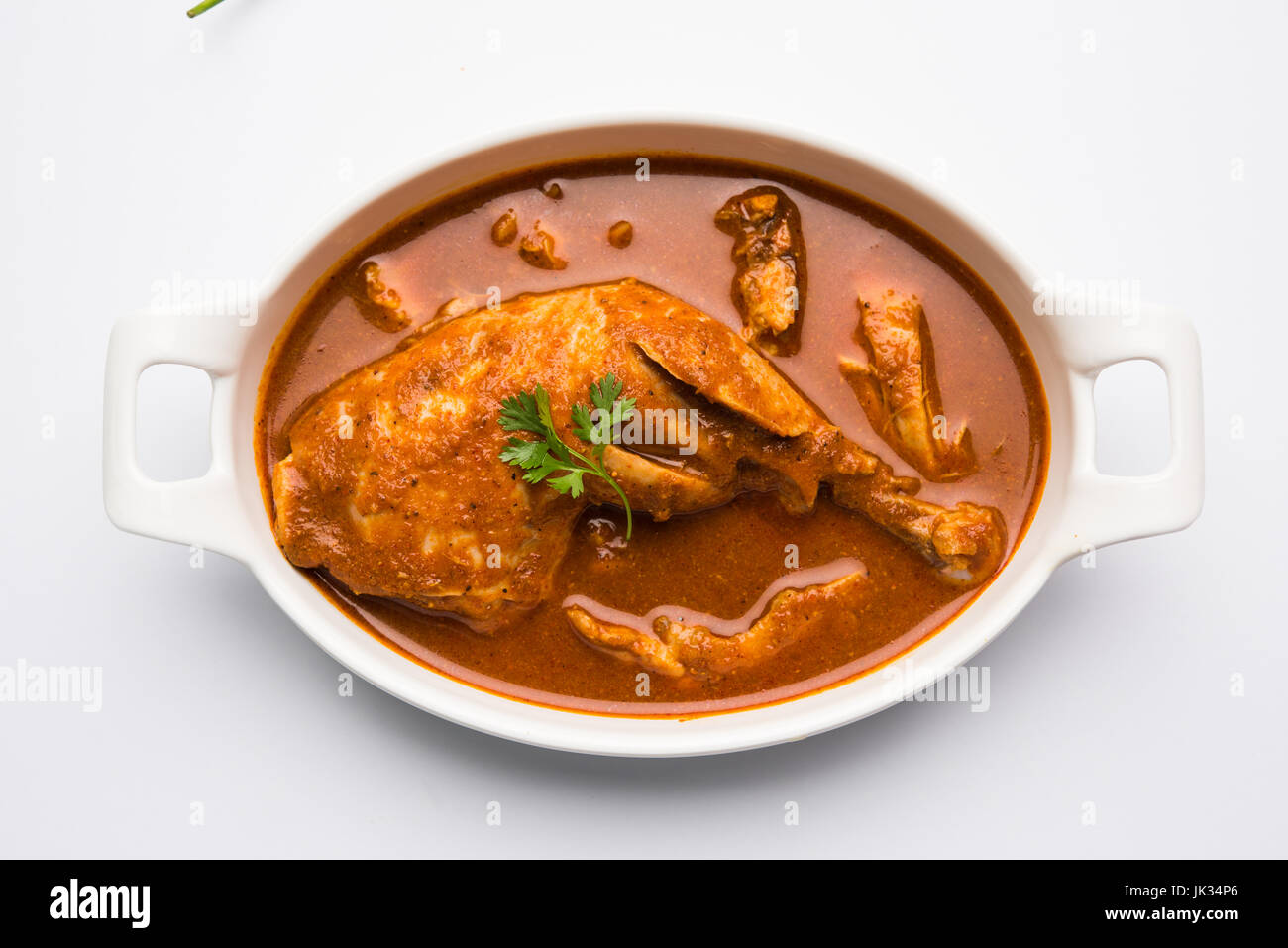 Indian spicy Chicken curry or masala chicken with prominent leg piece ...
