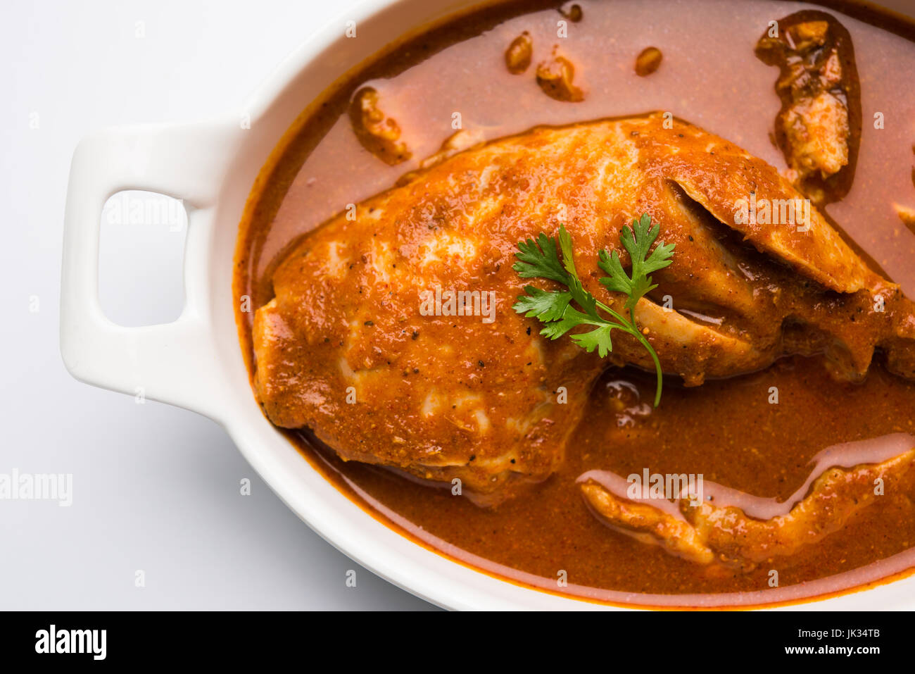 Indian spicy Chicken curry or masala chicken with prominent leg piece ...