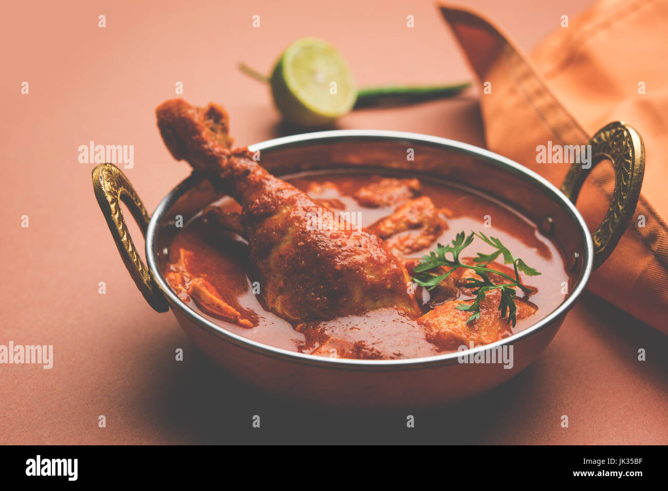 Indian spicy Chicken curry or masala chicken with prominent leg piece ...
