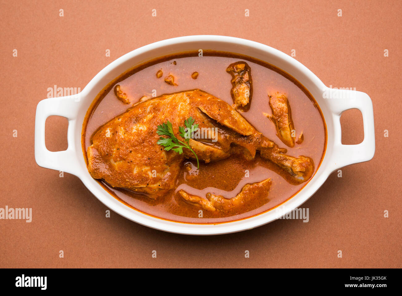 Indian spicy Chicken curry or masala chicken with prominent leg piece ...