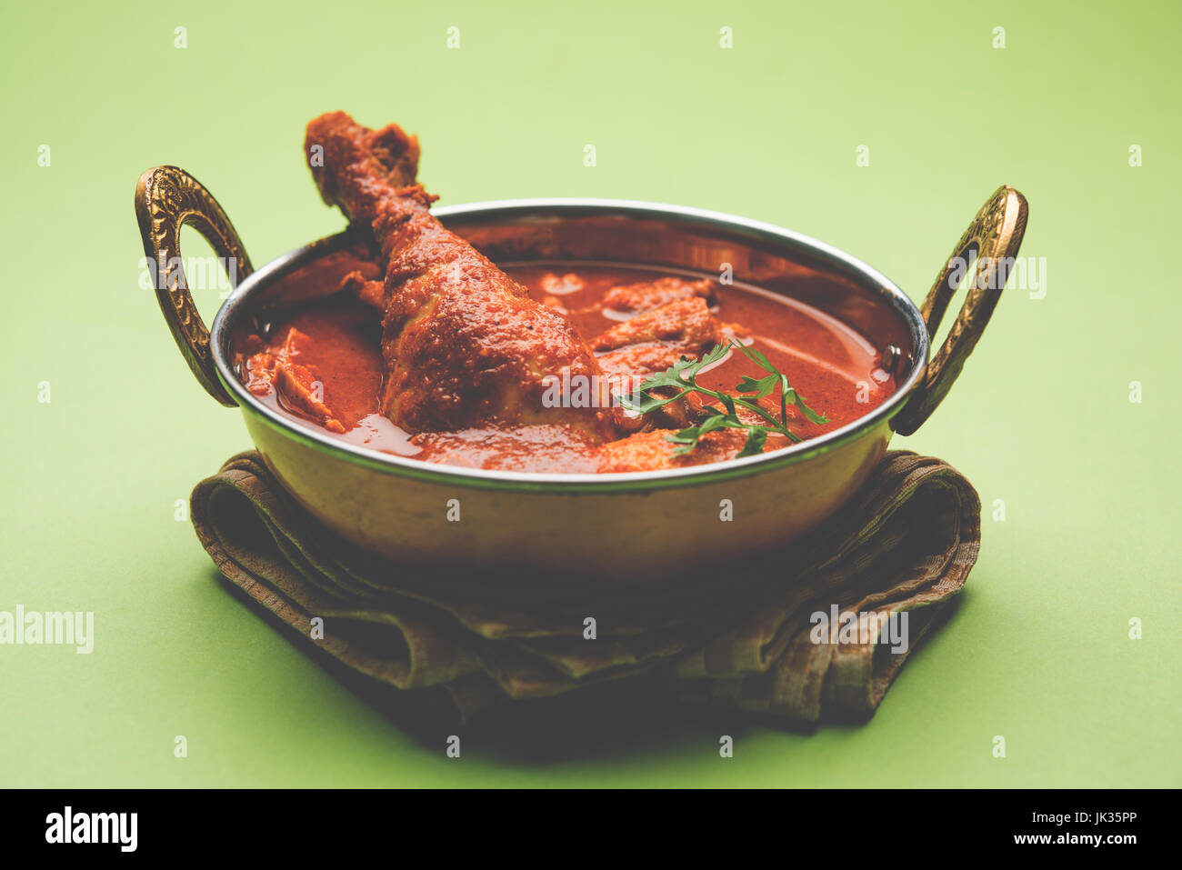 Indian spicy Chicken curry or masala chicken with prominent leg piece ...
