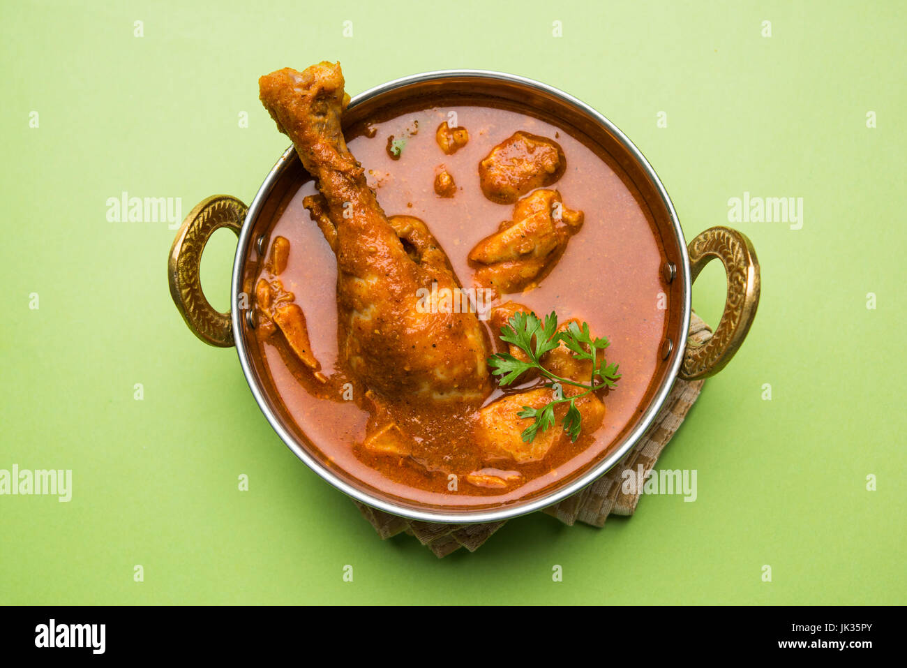 Indian spicy Chicken curry or masala chicken with prominent leg piece ...