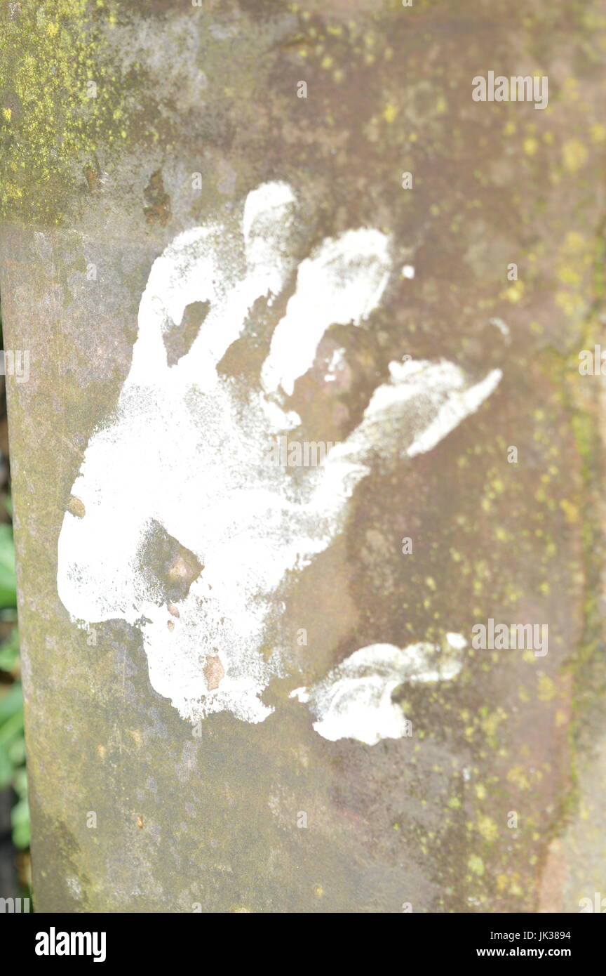White handprint fount on a stone wall Stock Photo - Alamy