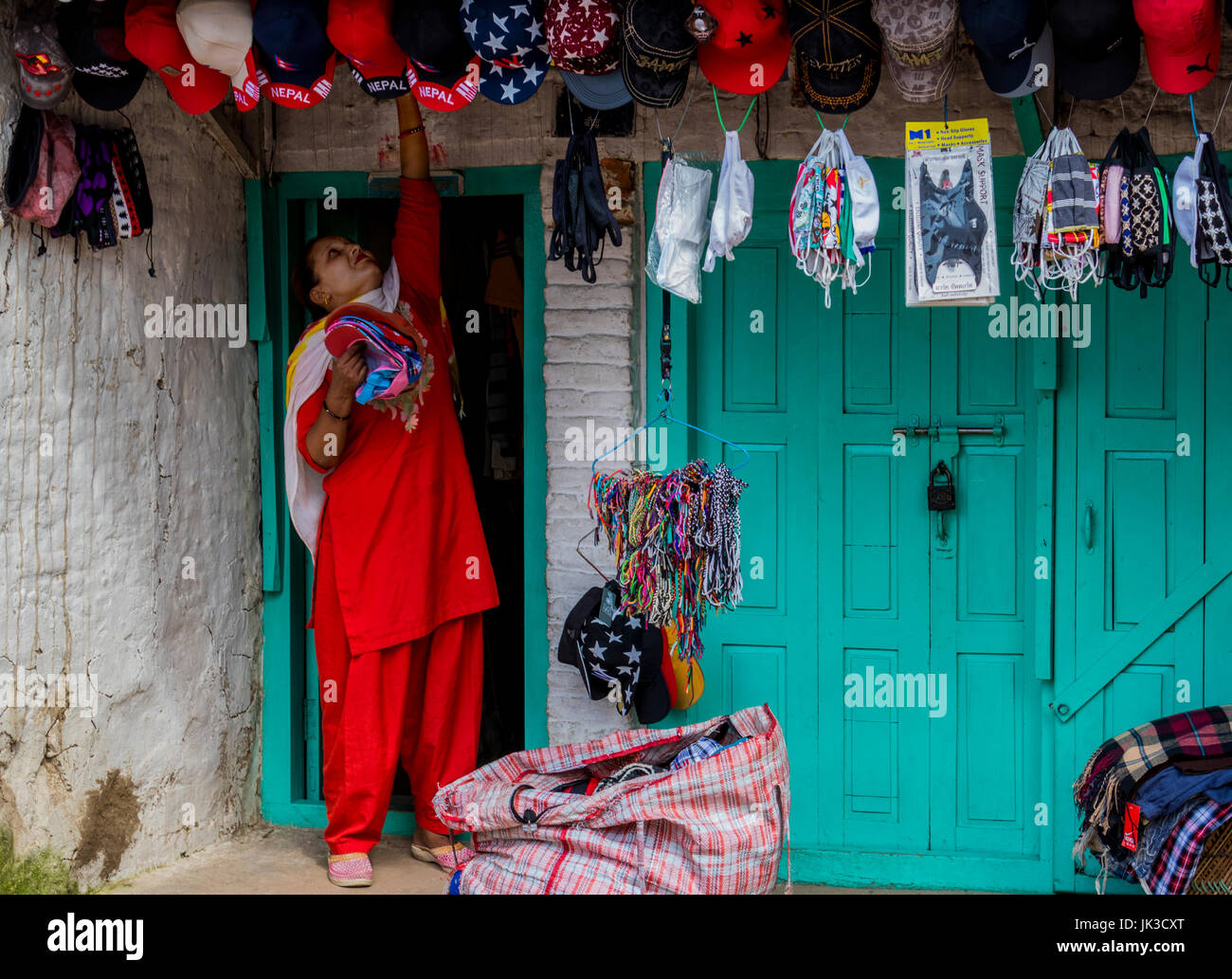 Shop keepers attending their premises on the streets of Boudhanath ...