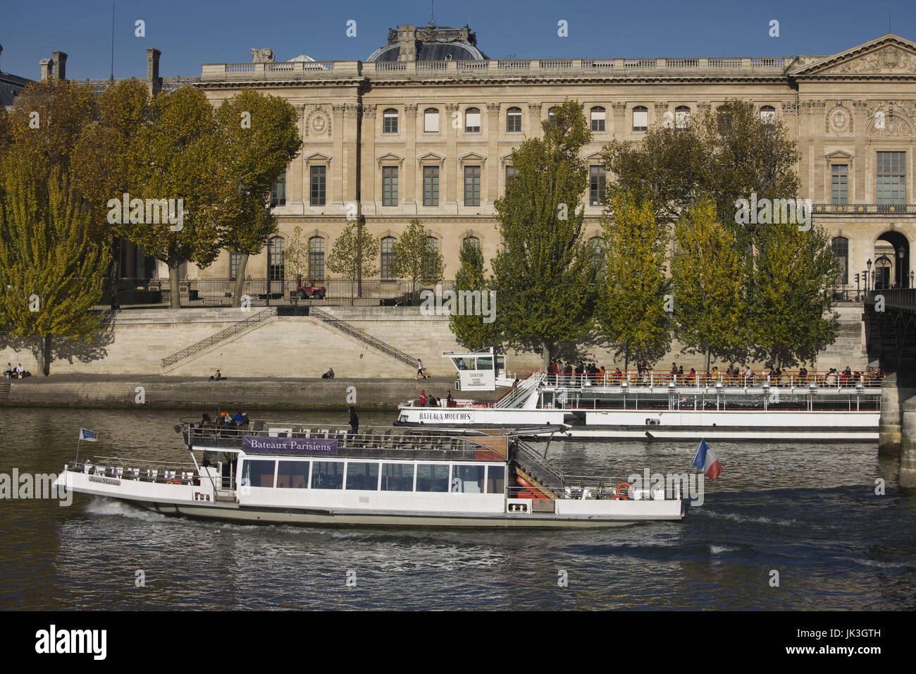 France, Paris, Seine River boats and Louvre Museum buildings, autumn ...