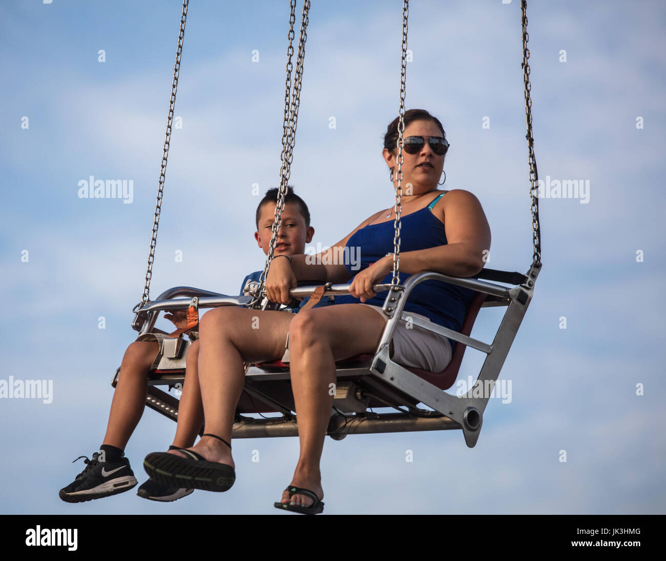 Fair goers on a swing ride on the midway of the Cal Expo State Fair in ...