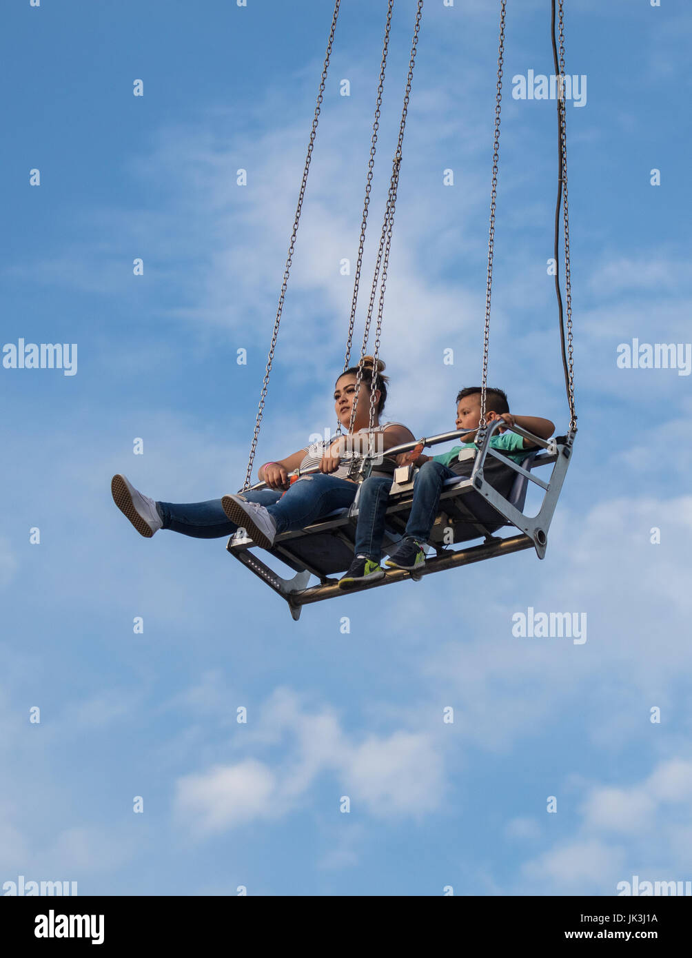 Fair goers on a swing ride on the midway of the Cal Expo State Fair in ...