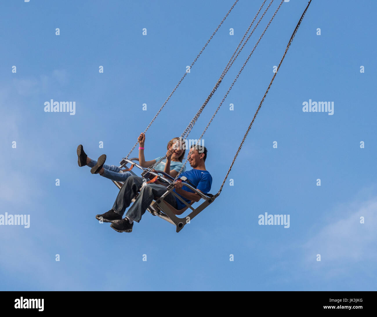 Fair goers on a swing ride on the midway of the Cal Expo State Fair in ...