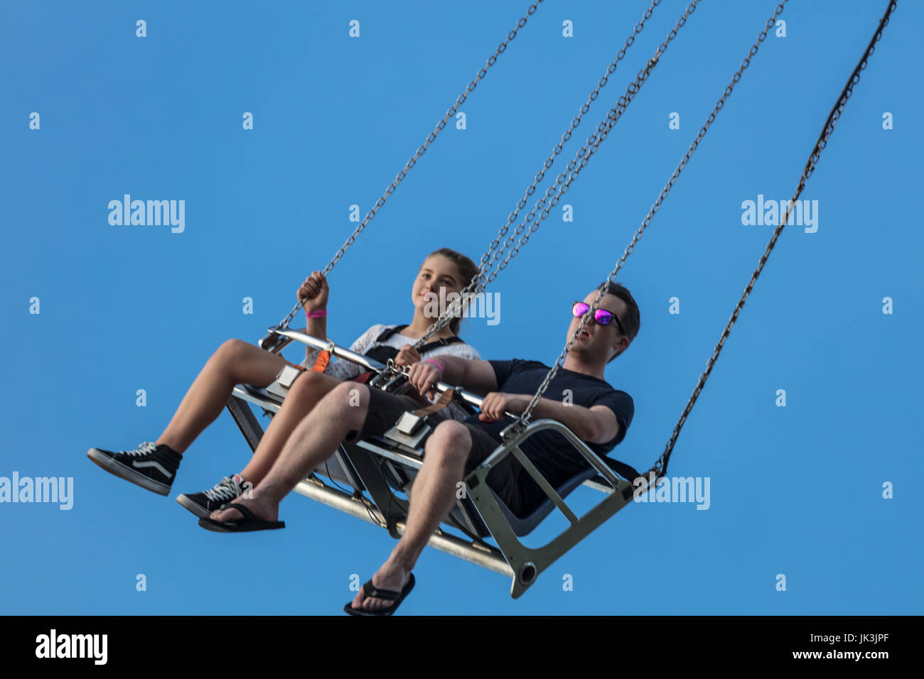 Fair goers on a swing ride on the midway of the Cal Expo State Fair in ...