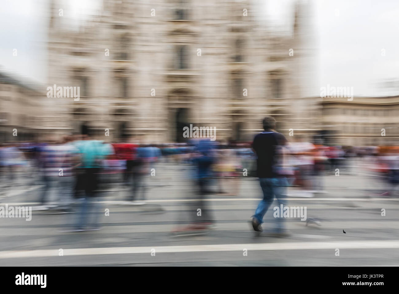 Panning photograph of people walking on a shopping street with camera ...