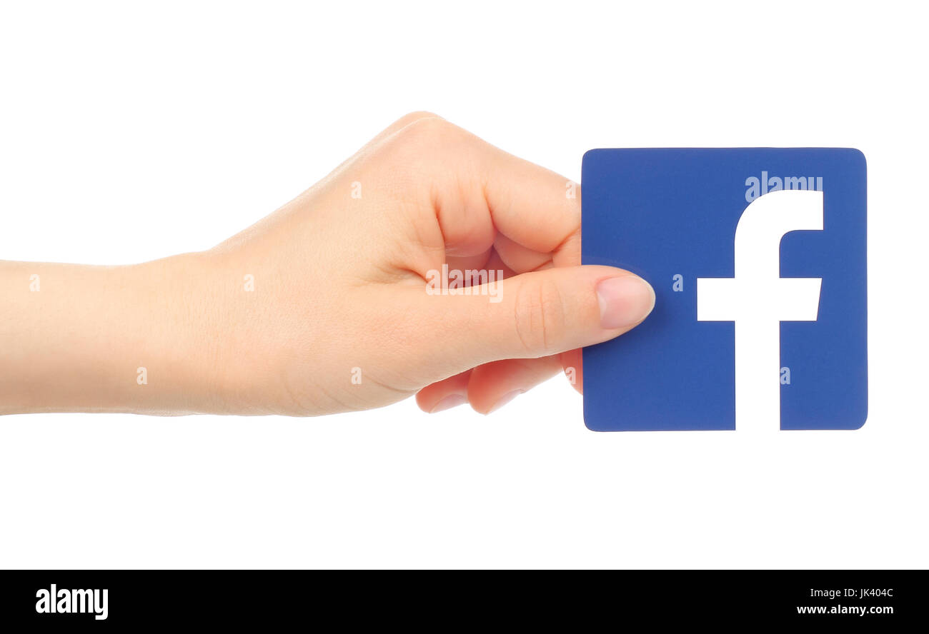 Kiev, Ukraine - May 18, 2016: Hand holds Facebook icon printed on paper ...