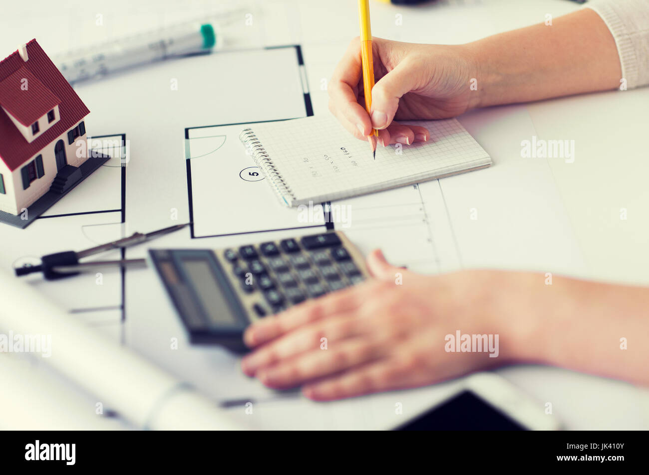 close up of hand on blueprint writing to notebook Stock Photo - Alamy