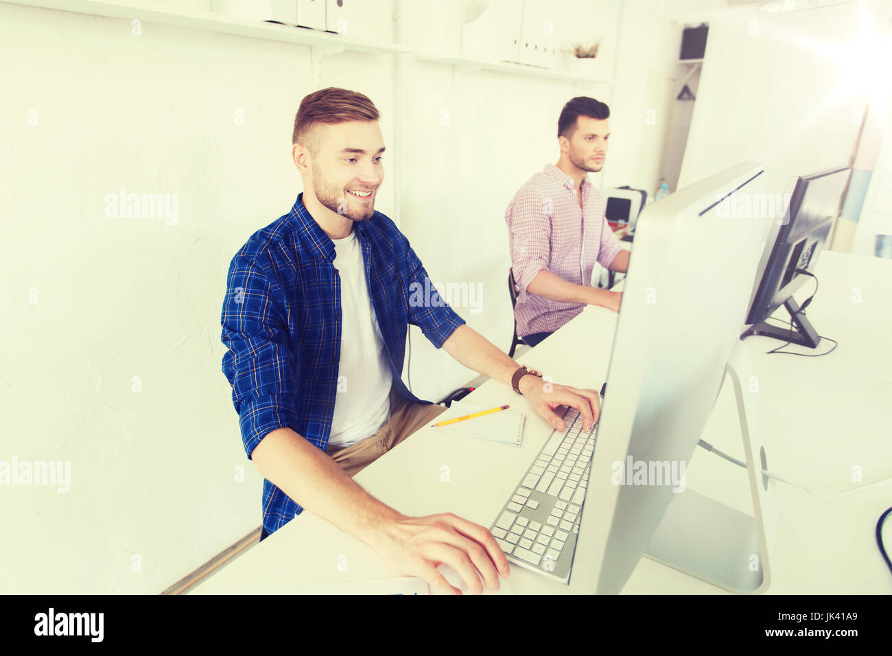 creative man or student with computer at office Stock Photo - Alamy