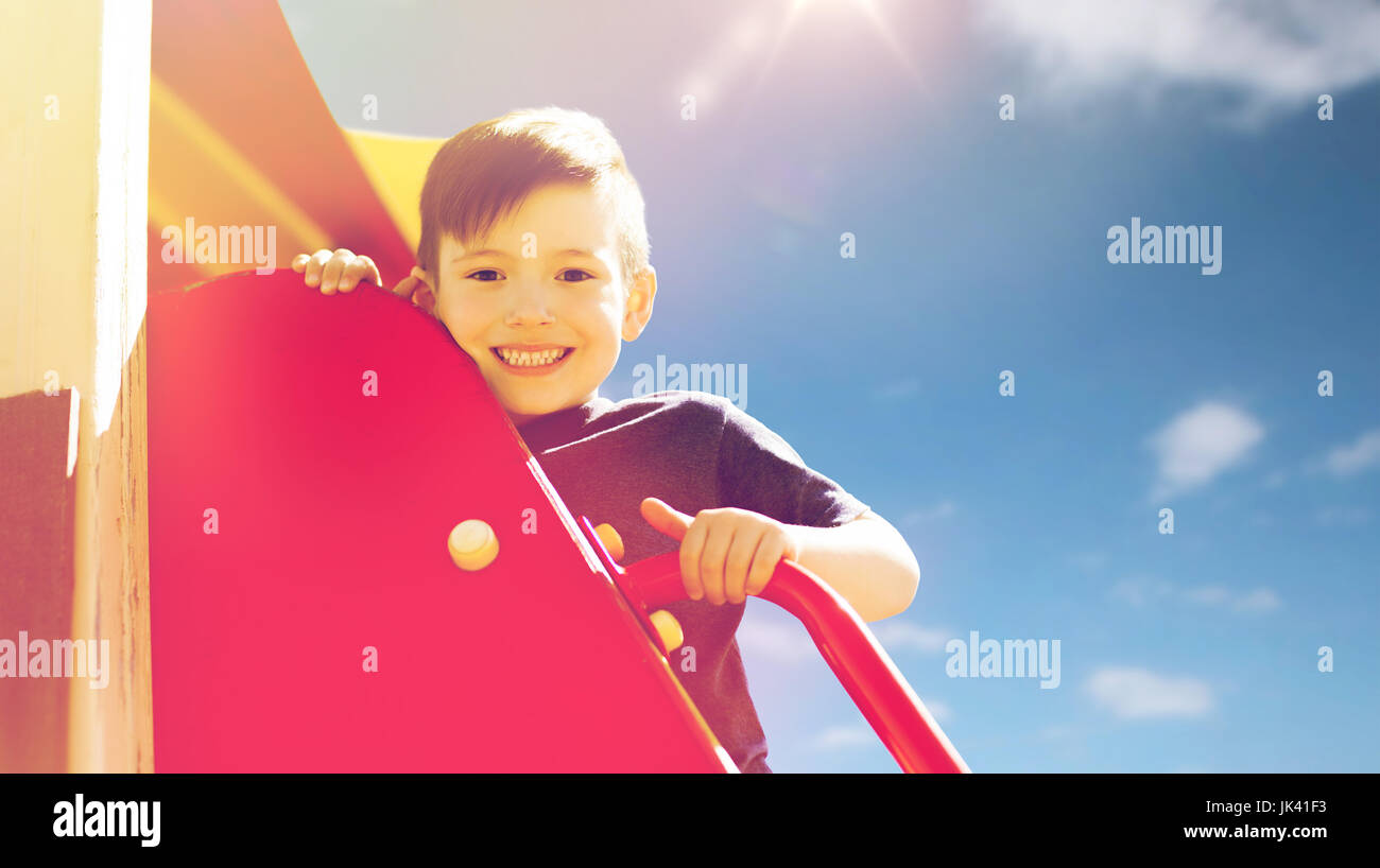 happy little boy climbing on children playground Stock Photo - Alamy