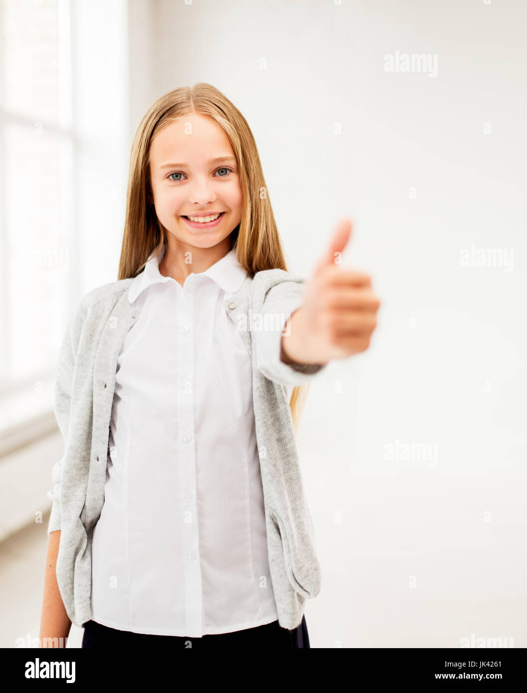 happy smiling student girl showing thumbs up Stock Photo - Alamy