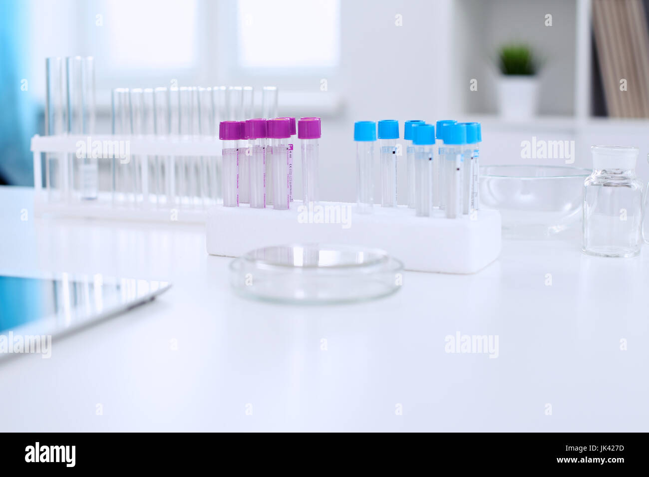 Research laboratory working space. Test tubes and tablet PC are lying ...