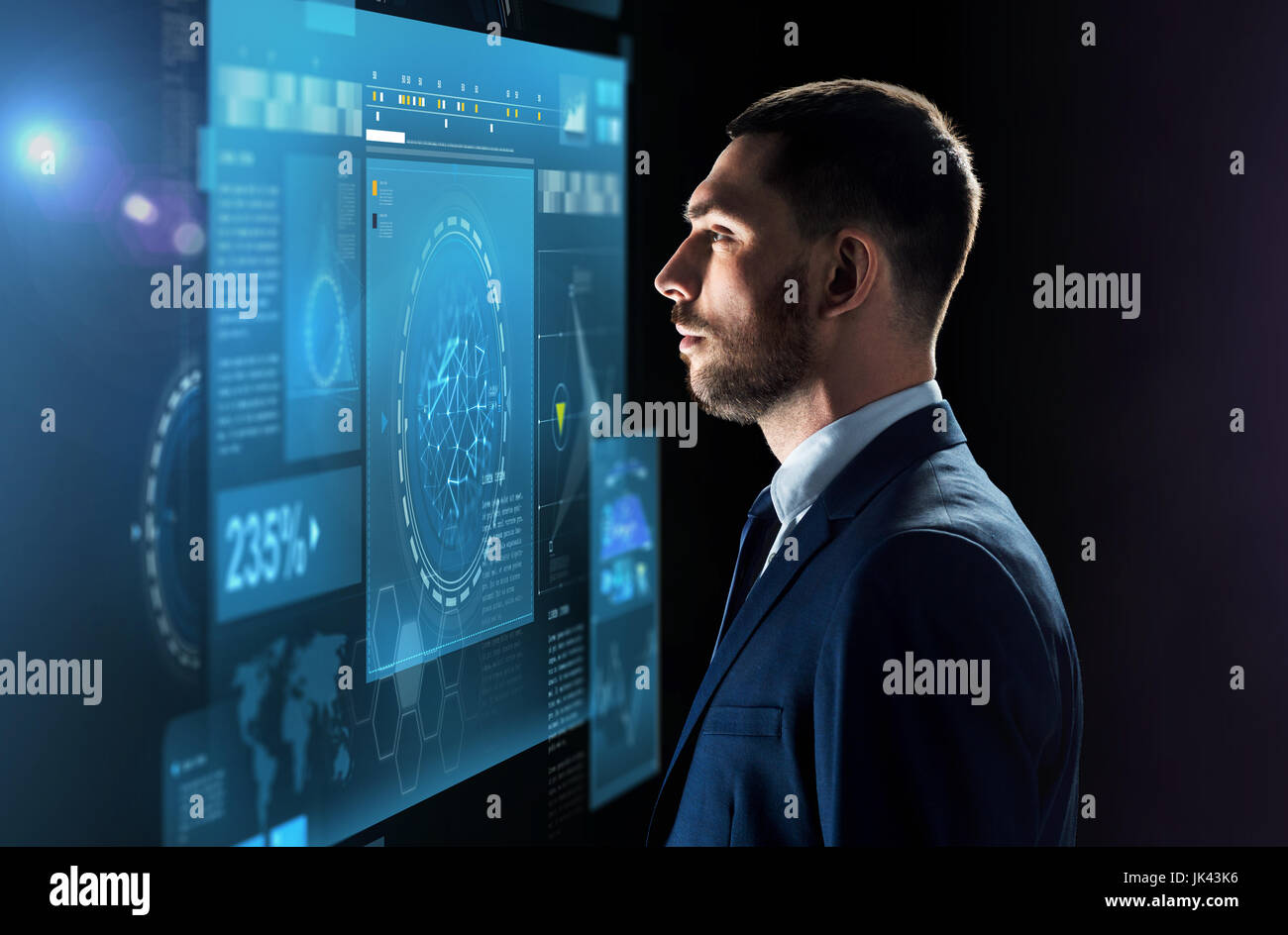 businessman looking at virtual screen over black Stock Photo - Alamy