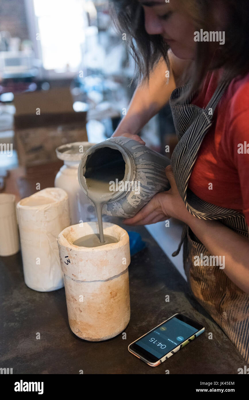 Caucasian woman pouring clay into pottery mold Stock Photo - Alamy