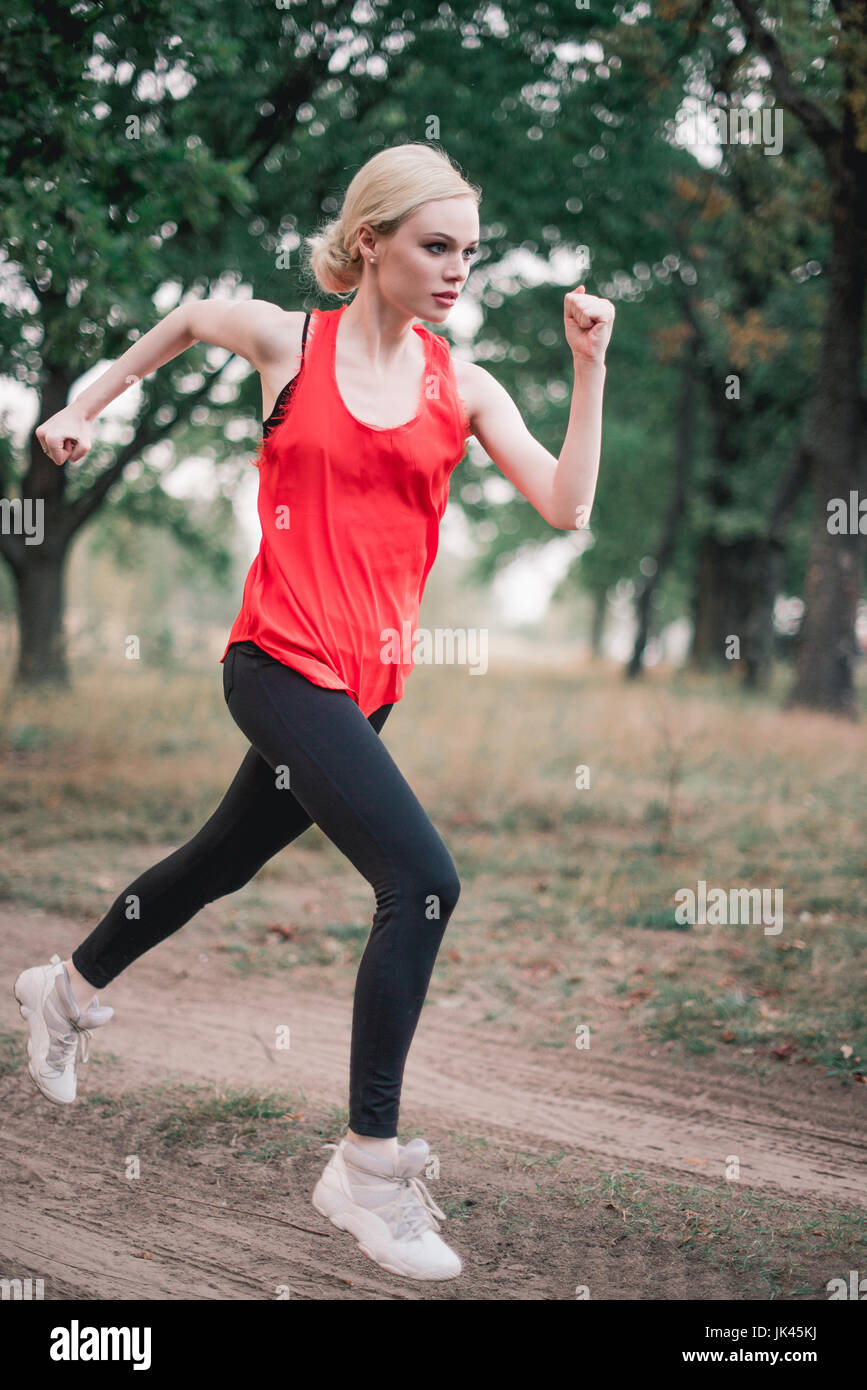 Young woman jogging at park Stock Photo - Alamy