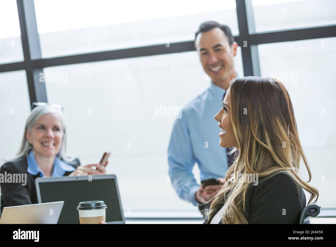Business people smiling in meeting Stock Photo - Alamy